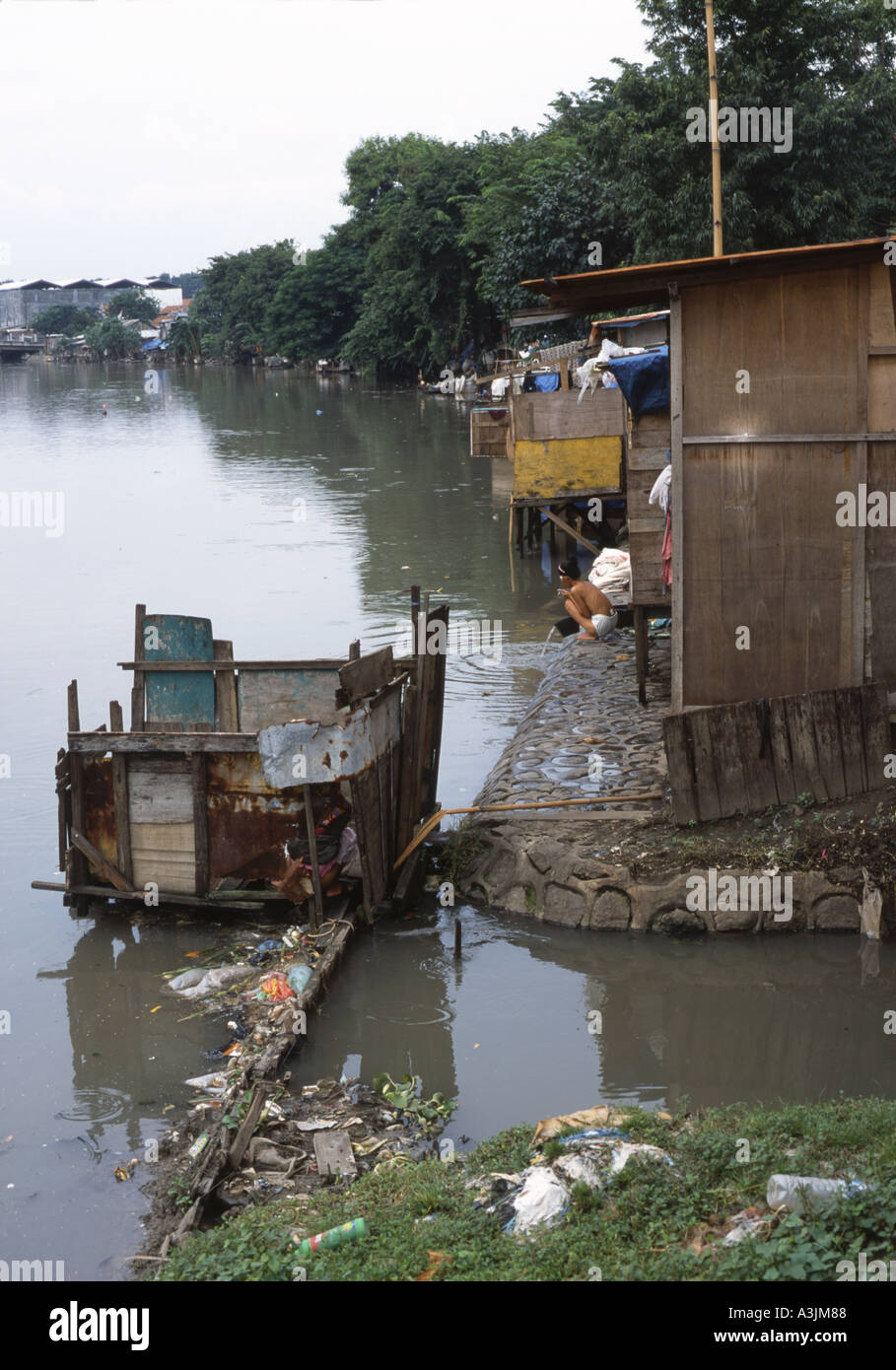 outside toilet built over the river near a shack in a slum area of ...