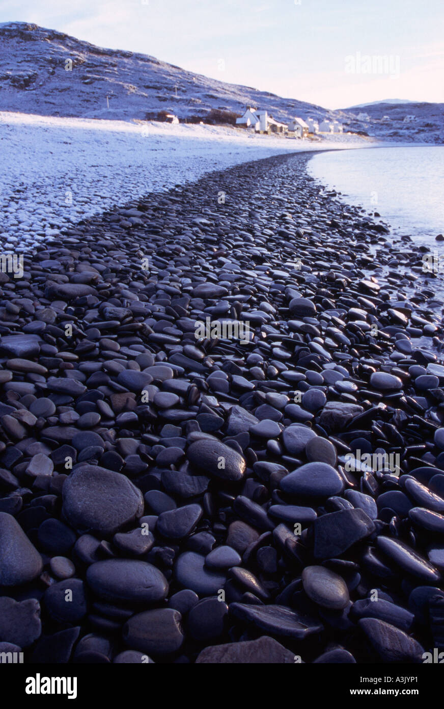 Pebble beach covered in snow, Ardmair Bay, near Ullapool, Scottish ...