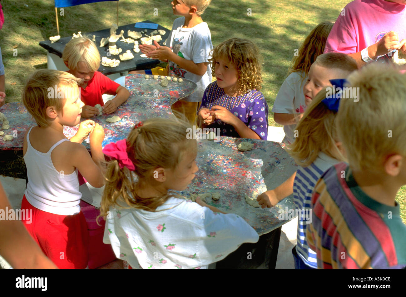 Kids age 5 working on 4H clay art project at Minnesota State Fair. St ...