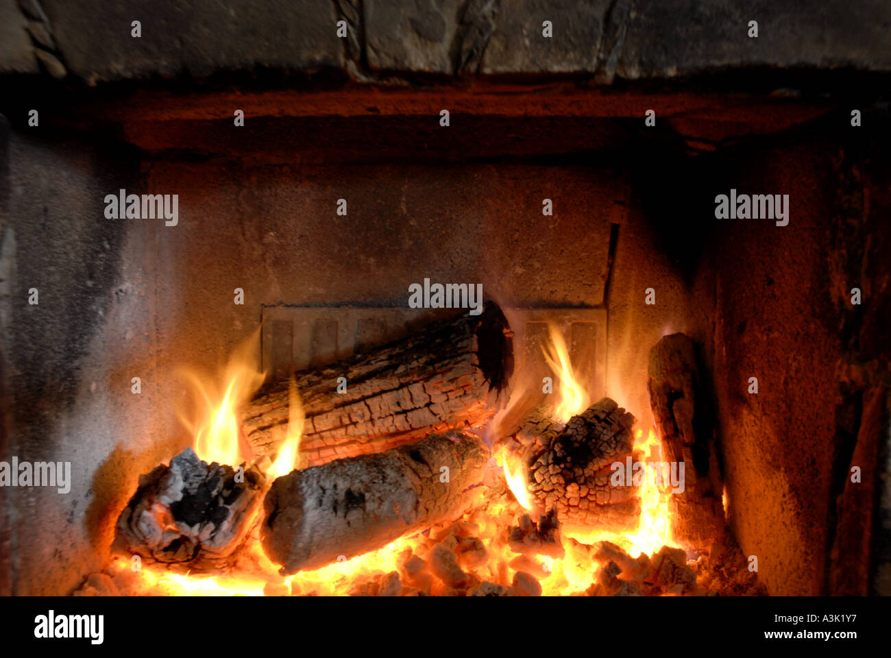 Fireplace with a log fire Stock Photo - Alamy