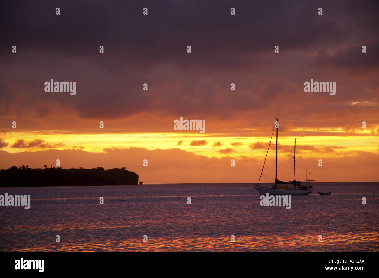 Sunset with a yacht over Port Vila harbour in Vanuatu Stock Photo - Alamy