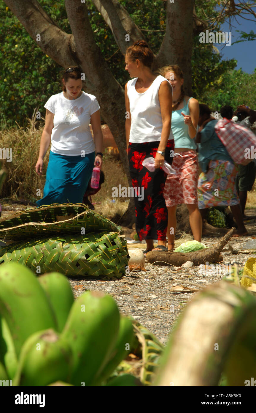 Tourist walk around the market in Lenakel on Tanna island in Vanuatu in ...