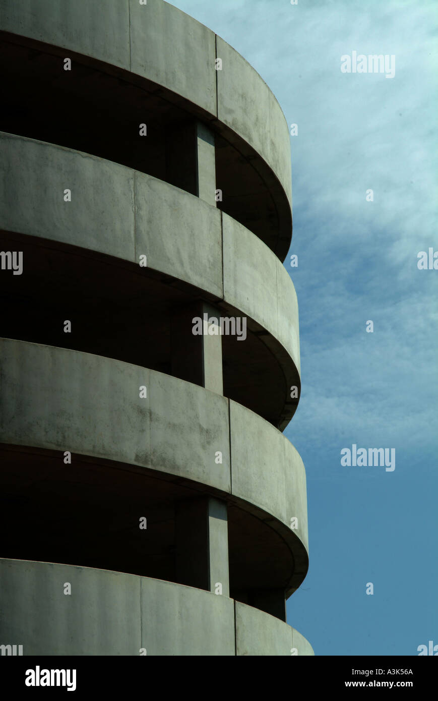 Side of round concrete car park access ramp against blue sky Stock ...