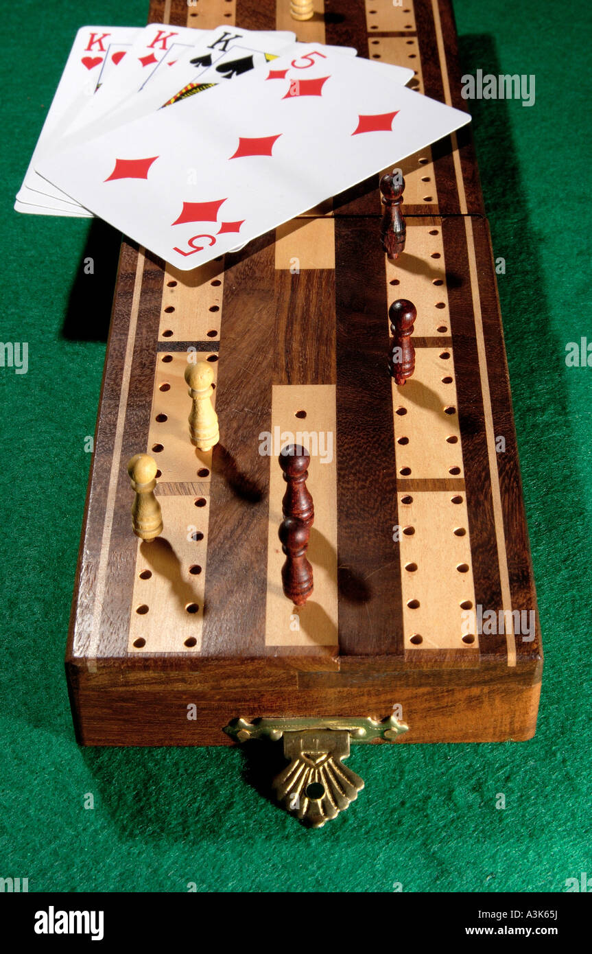 Traditional wooden cribbage board with wooden shaped pegs and a good ...
