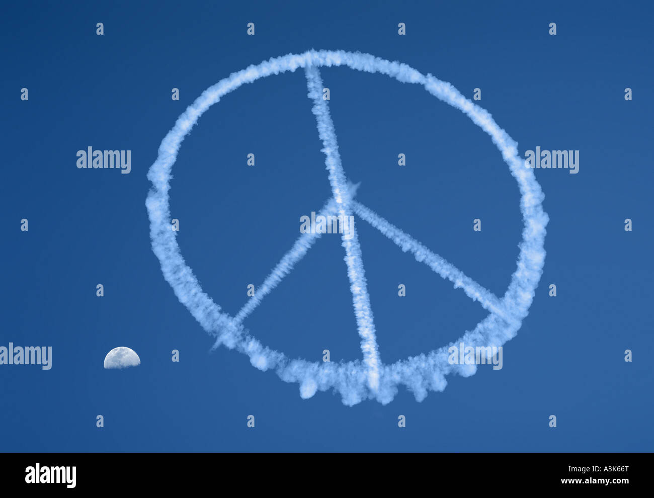 Skywriting - a peace sign against clear blue sky with a nice half moon ...