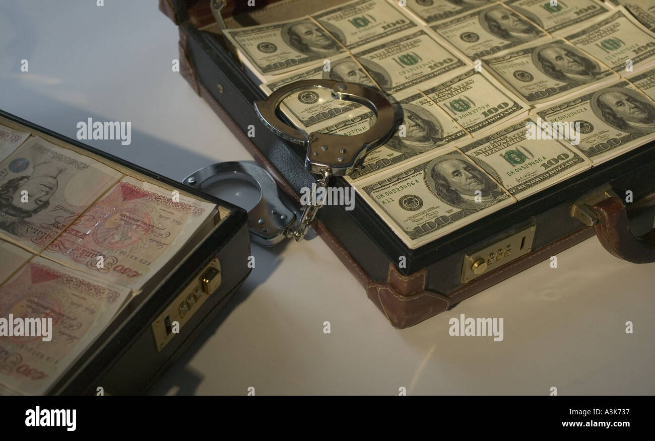 Closeup of dollar bills in briefcase with handcuffs sterling briefcase ...