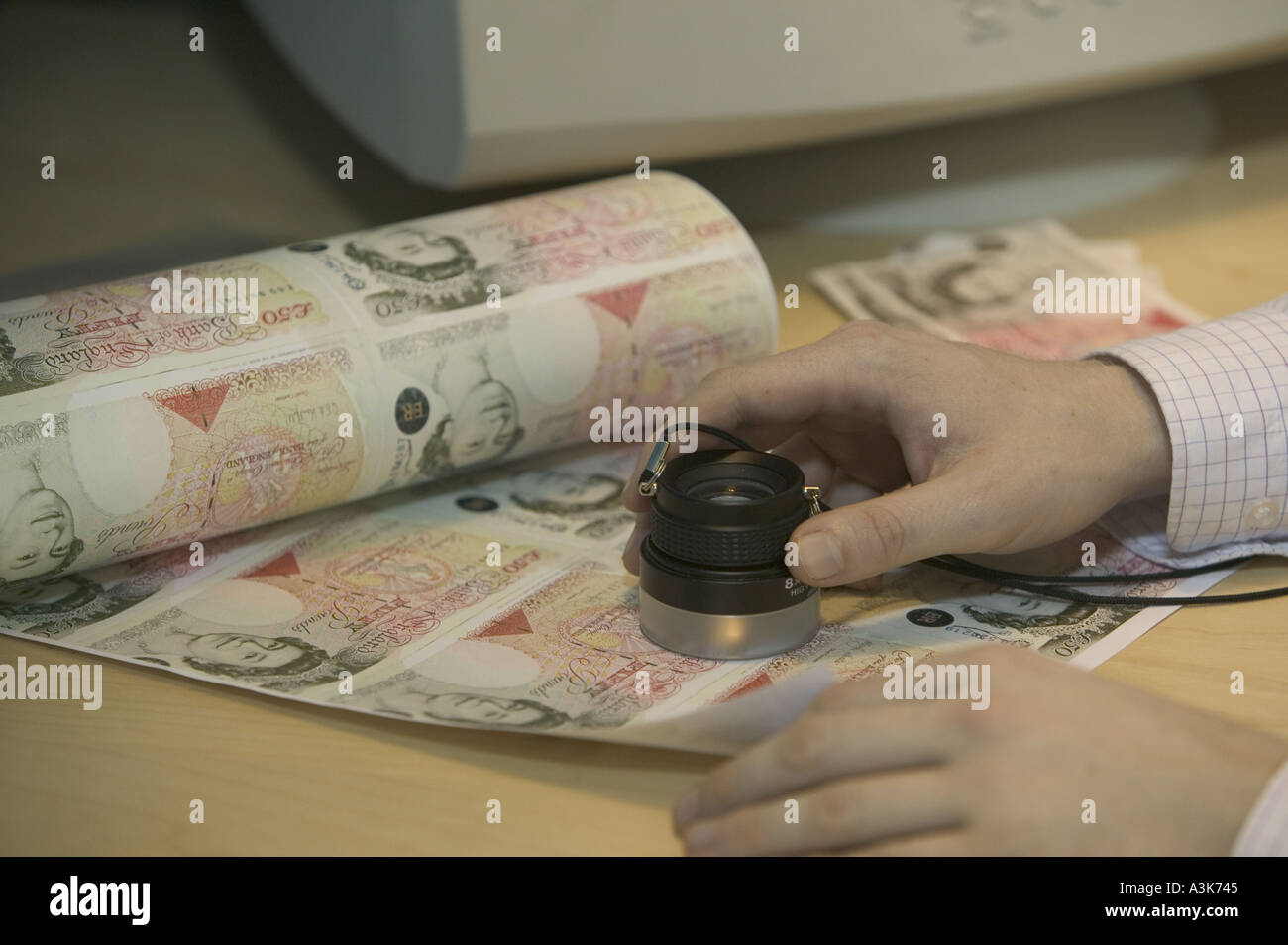 Closeup of man checking detail on printed banknotes Stock Photo - Alamy