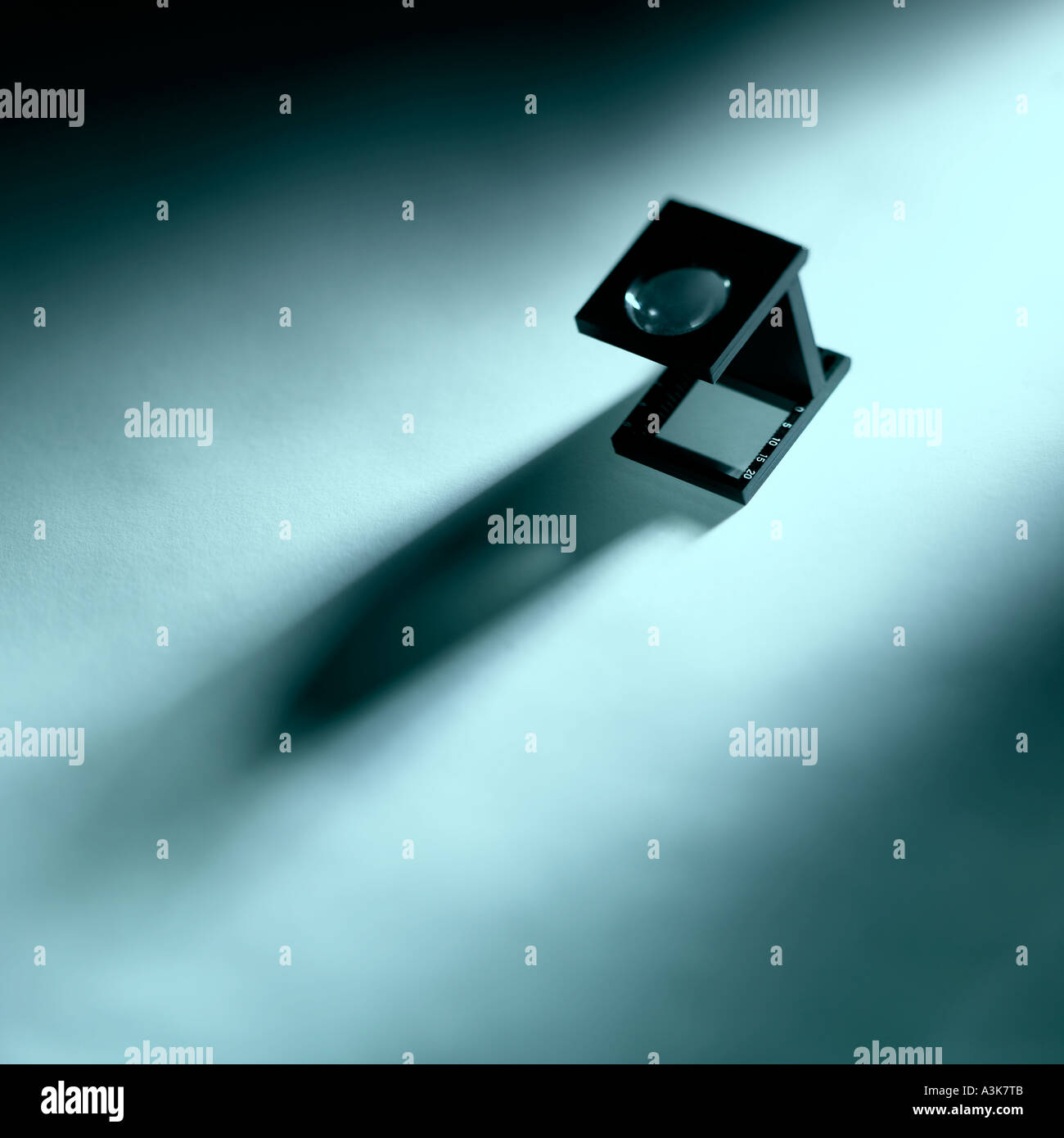 square shot lupe on white background with strong diagonal shadow and ...