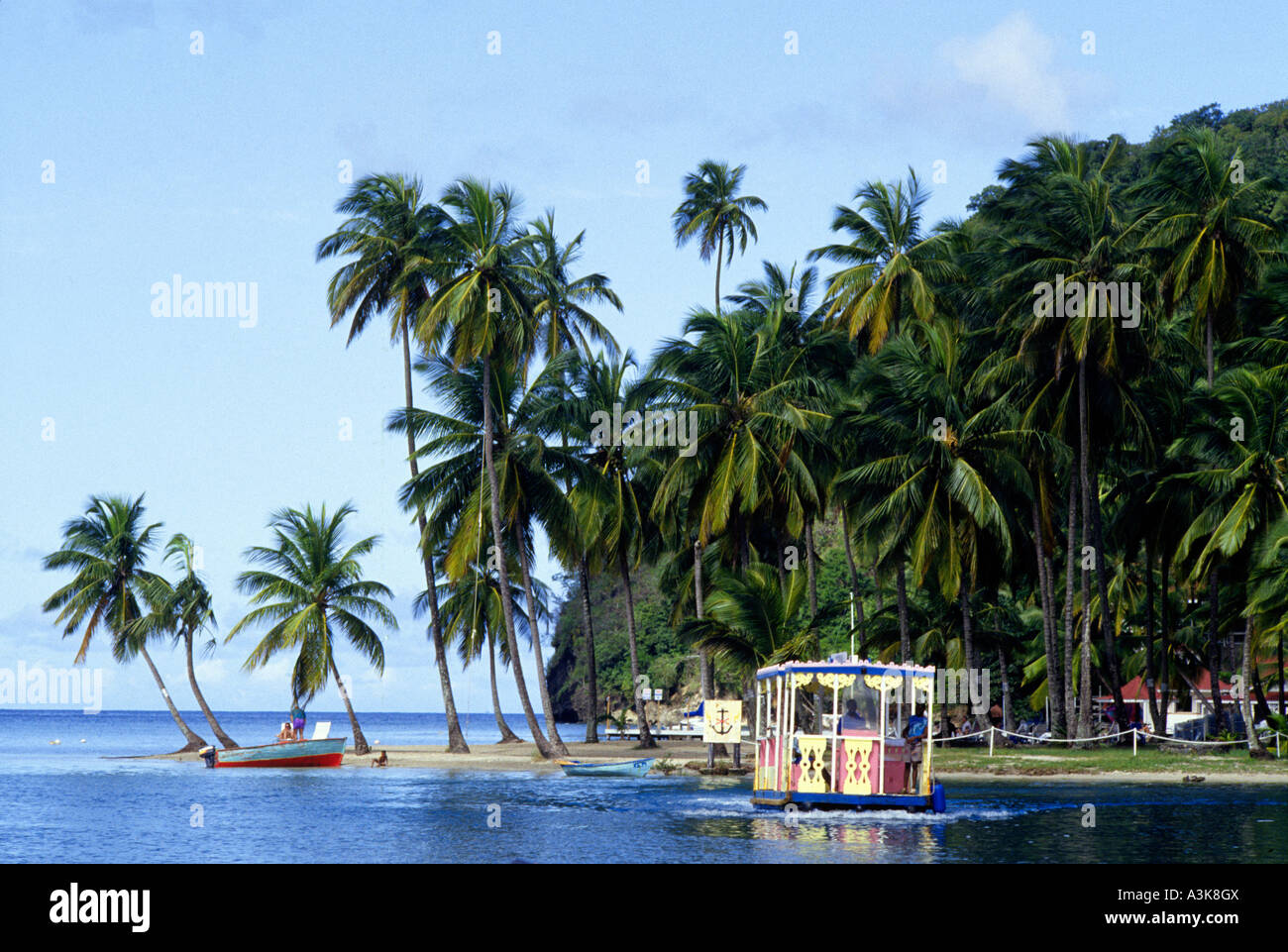 Little ferry sets out across Marigot Bay in St Lucia in theCaribbean ...