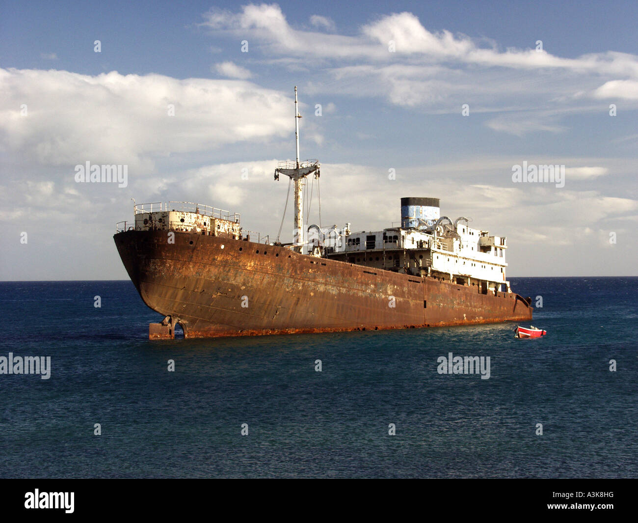 Rusting hulk of a ship in a blue sea in Lanzarote Stock Photo - Alamy