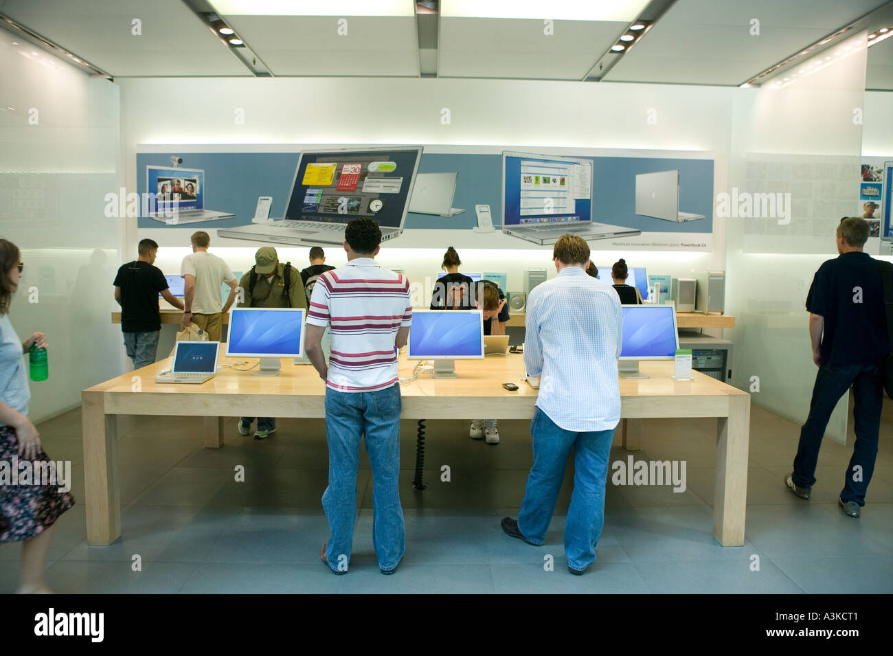 People try out products at the Apple store in SoHo in New York City USA ...