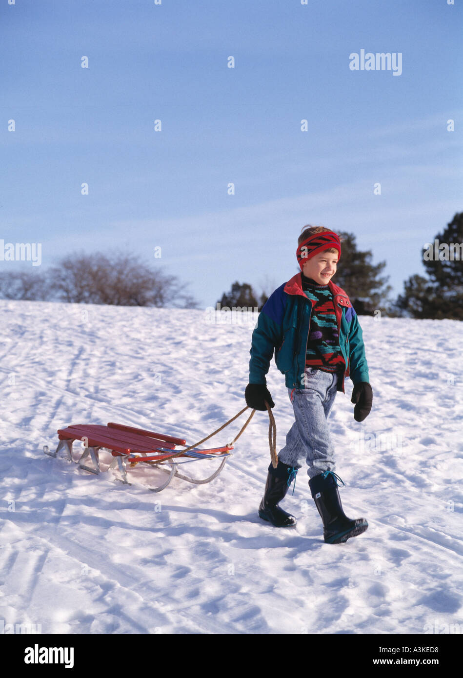 Boy with sled hi-res stock photography and images - Alamy