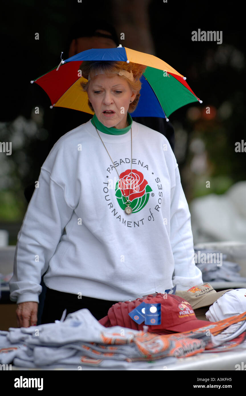 Female volunteer at a Tournament of Roses booth selling souvenirs ...