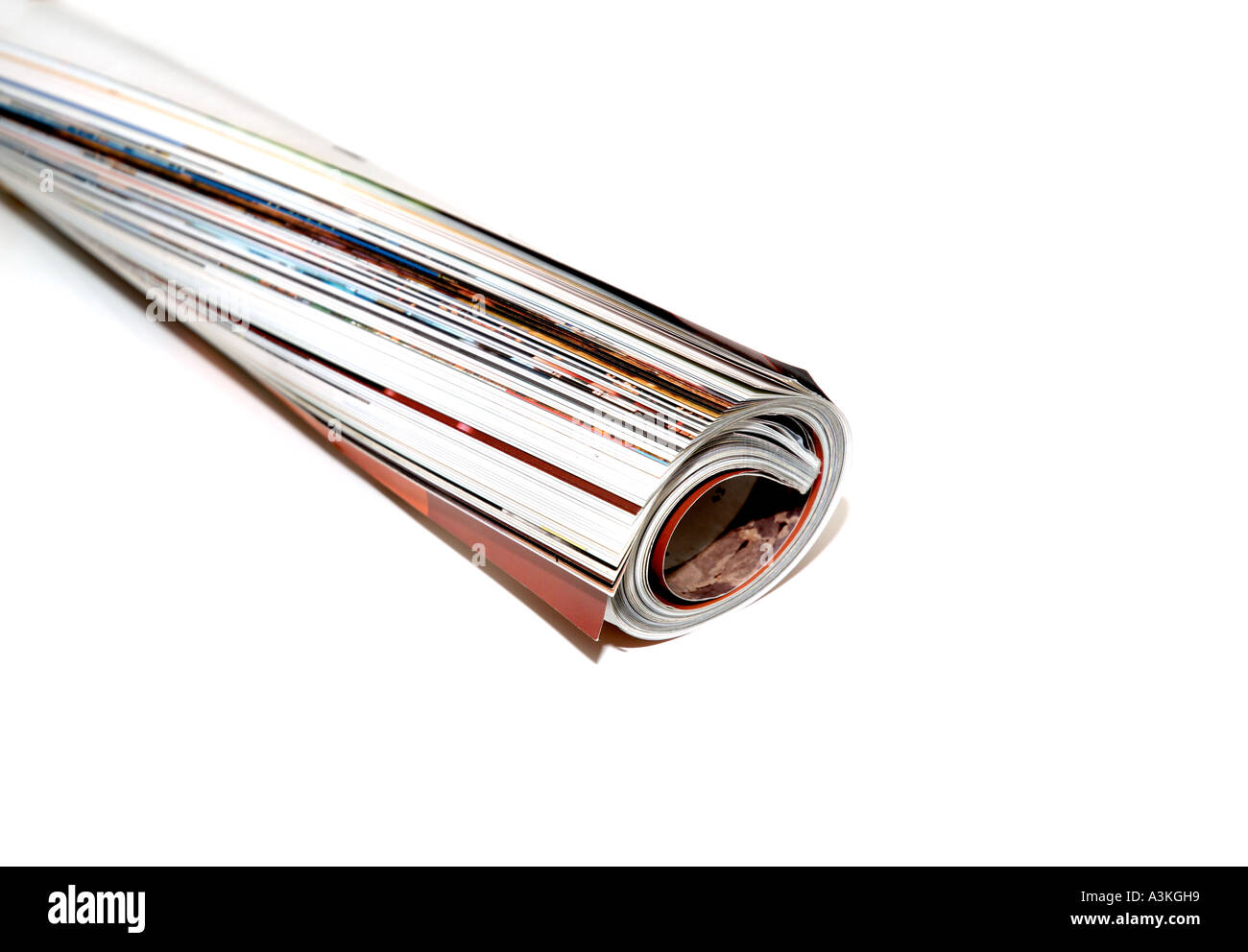 Rolled up magazine over white isolated background Stock Photo - Alamy