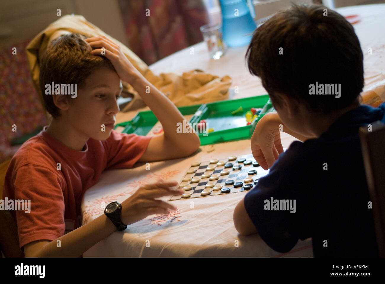 Two boys playing checkers Stock Photo - Alamy