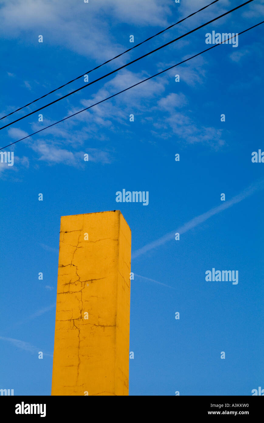 Tall brick chimney painted yellow Stock Photo - Alamy