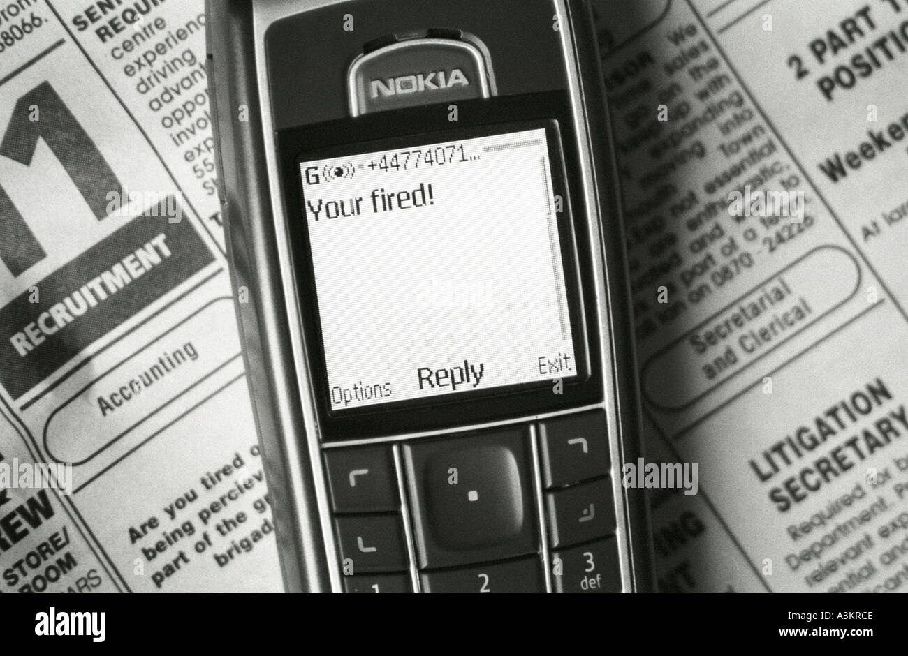 A mobile phone text massage saying your fired you re fired Stock Photo ...