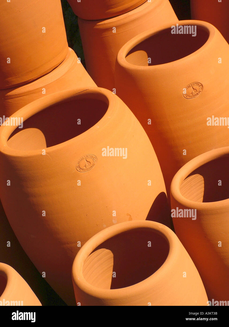 Large terracotta earthenware pots stacked in the sun Morris James ...