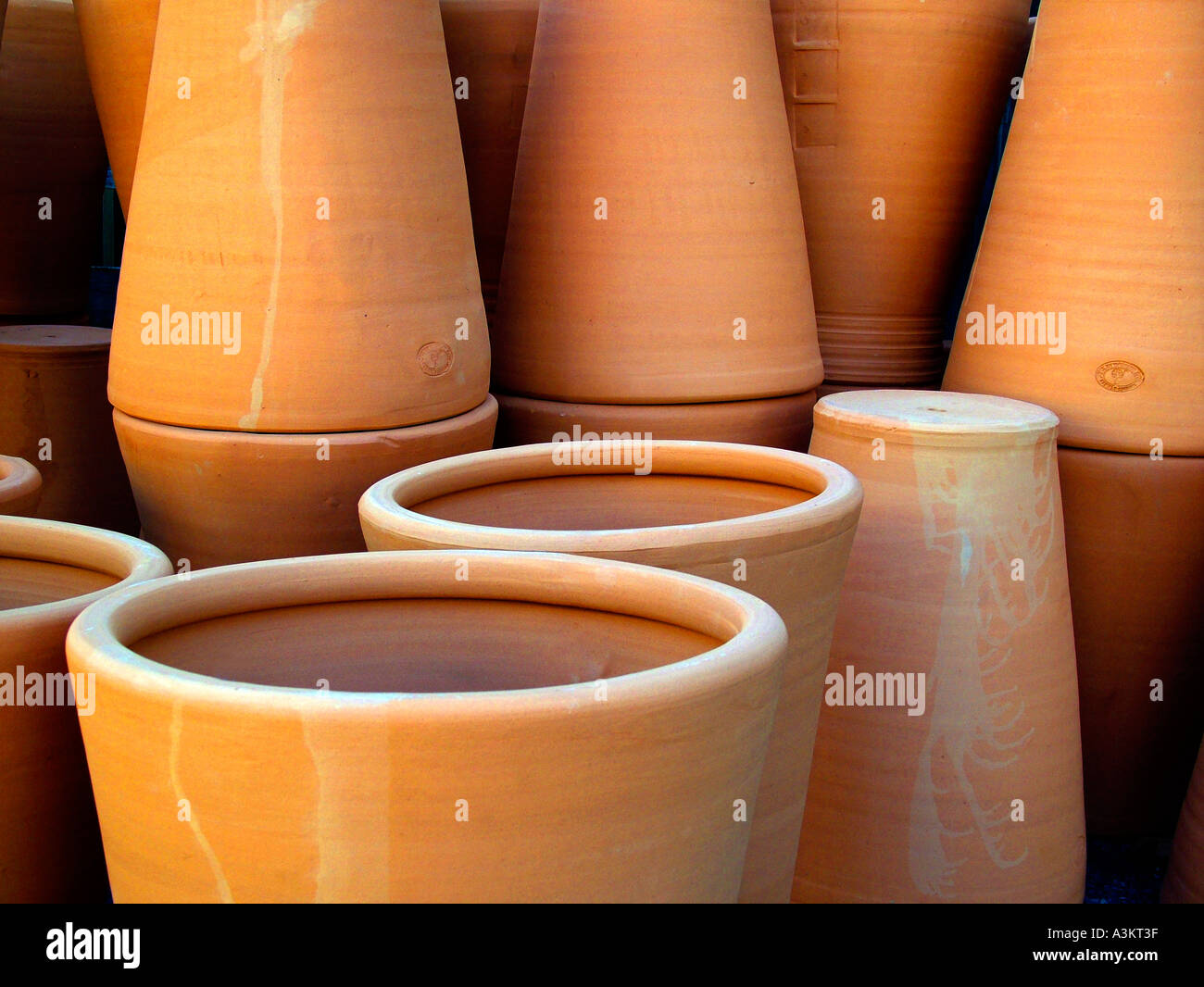 Large terracotta earthenware pots stacked in the sun Morris James ...