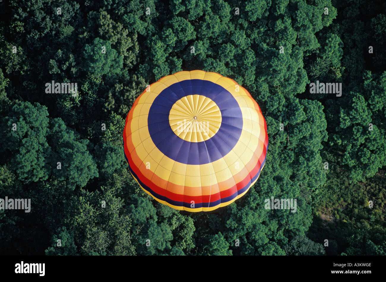 Hot air balloon hovering over countryside Stock Photo - Alamy