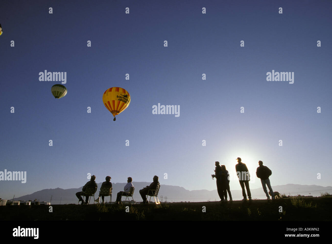 Early morning spectators watching the mass ascent of balloons at the ...