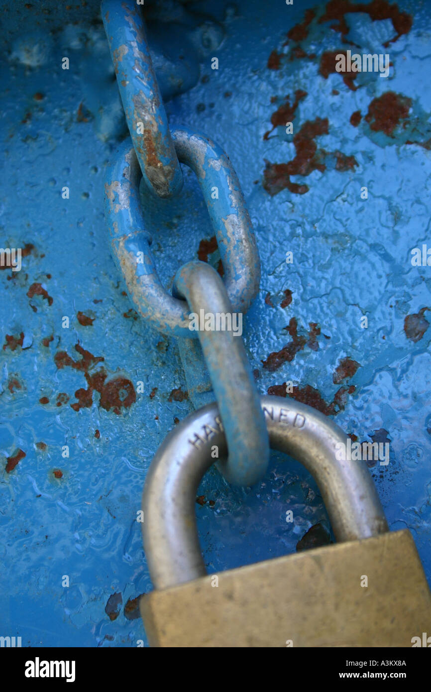 Padlock on Chain against blue Stock Photo - Alamy