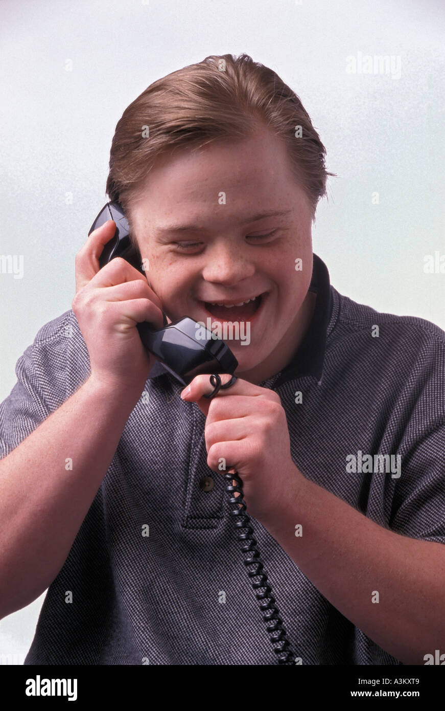 Boy with Down Syndrome talking on phone Stock Photo - Alamy