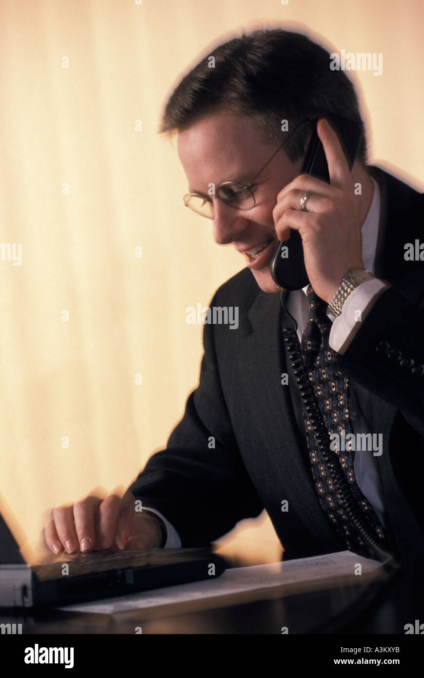 A busy executive using a telephone Stock Photo - Alamy