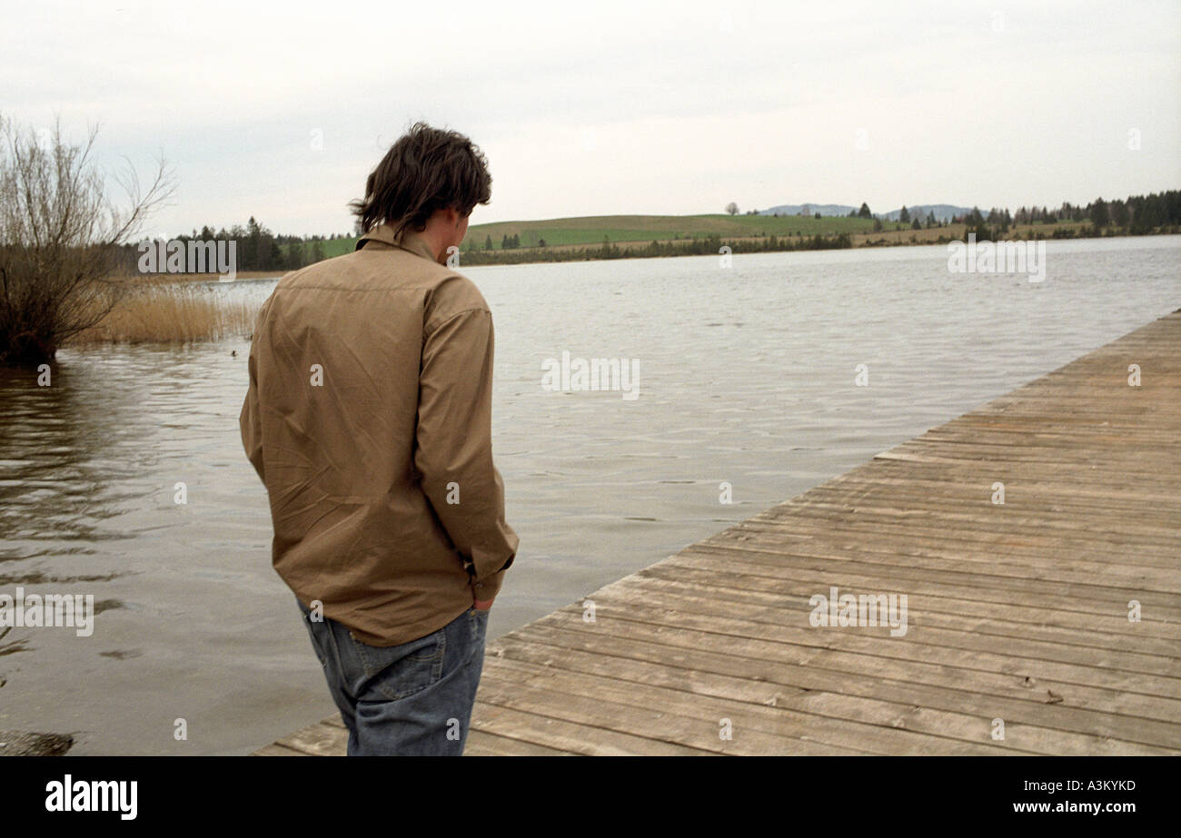 rear view of man walking on pier Stock Photo - Alamy
