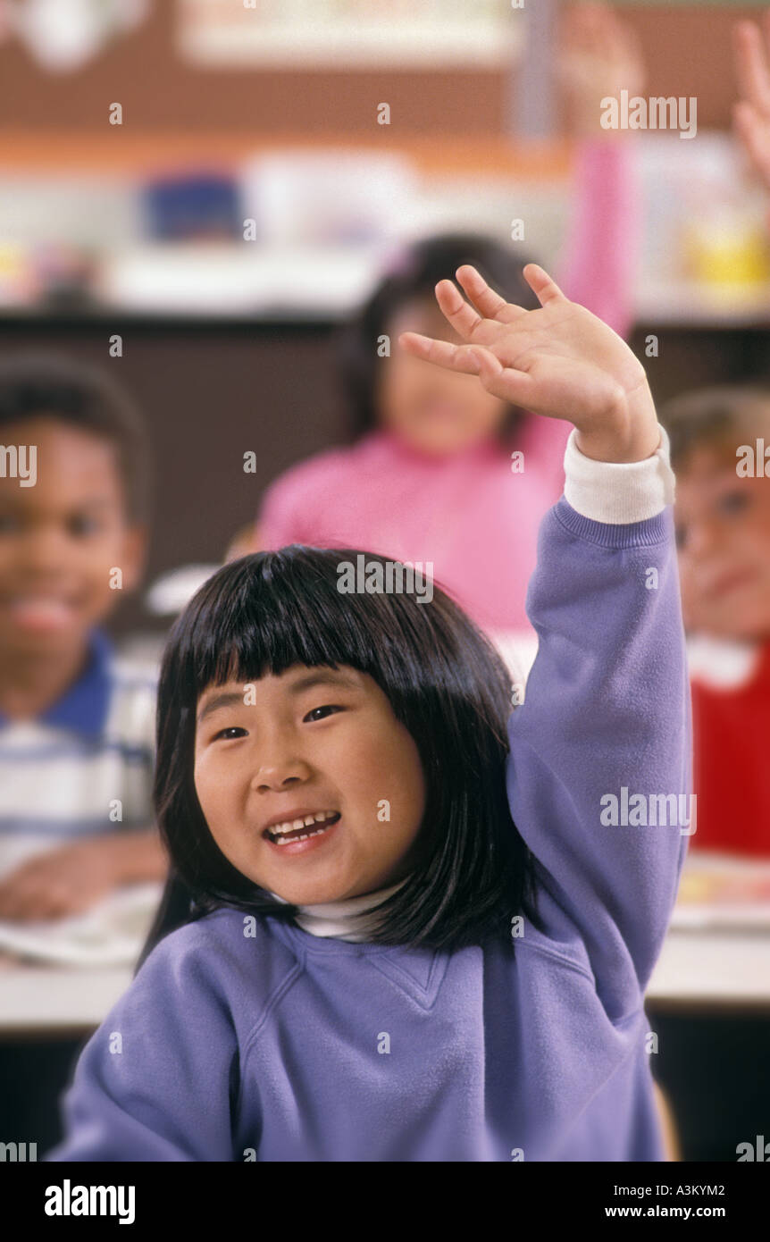 Female Asian student raising hand in elementary school classroom Stock Photo - Alamy