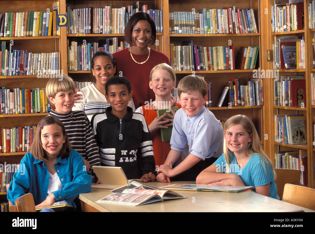 Portrait of librarian and students in middle school library Stock Photo ...