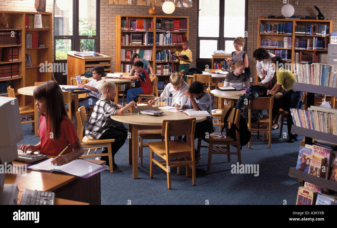 Multiracial group of students in middle school library Stock Photo - Alamy