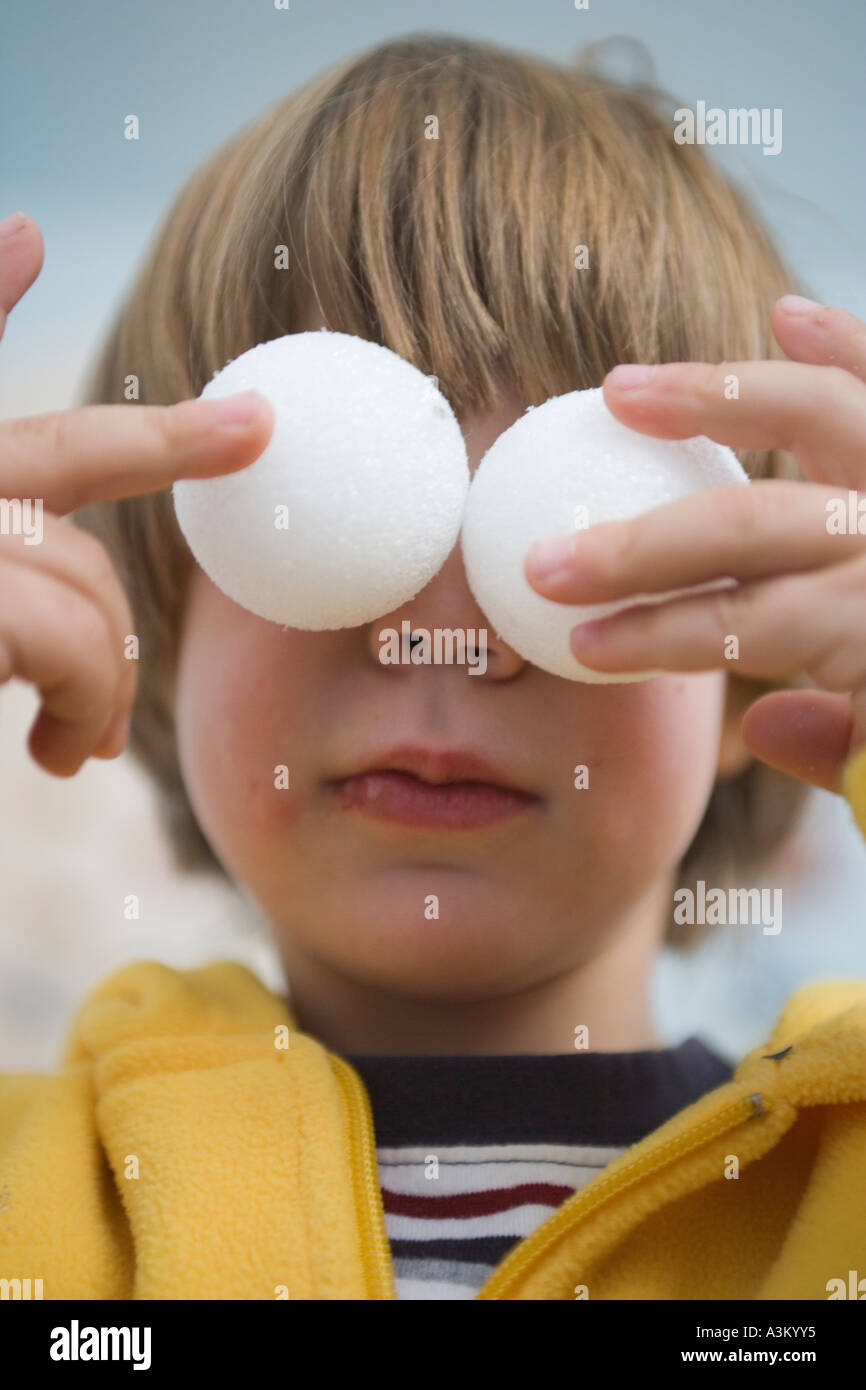 child holding styrofoam balls over eyes Stock Photo - Alamy