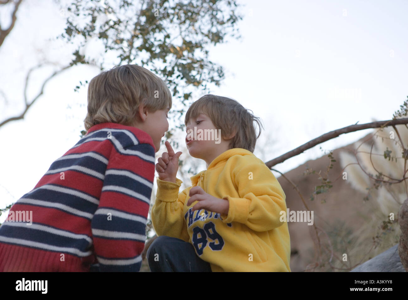 Older kid talking younger kid hi-res stock photography and images - Alamy