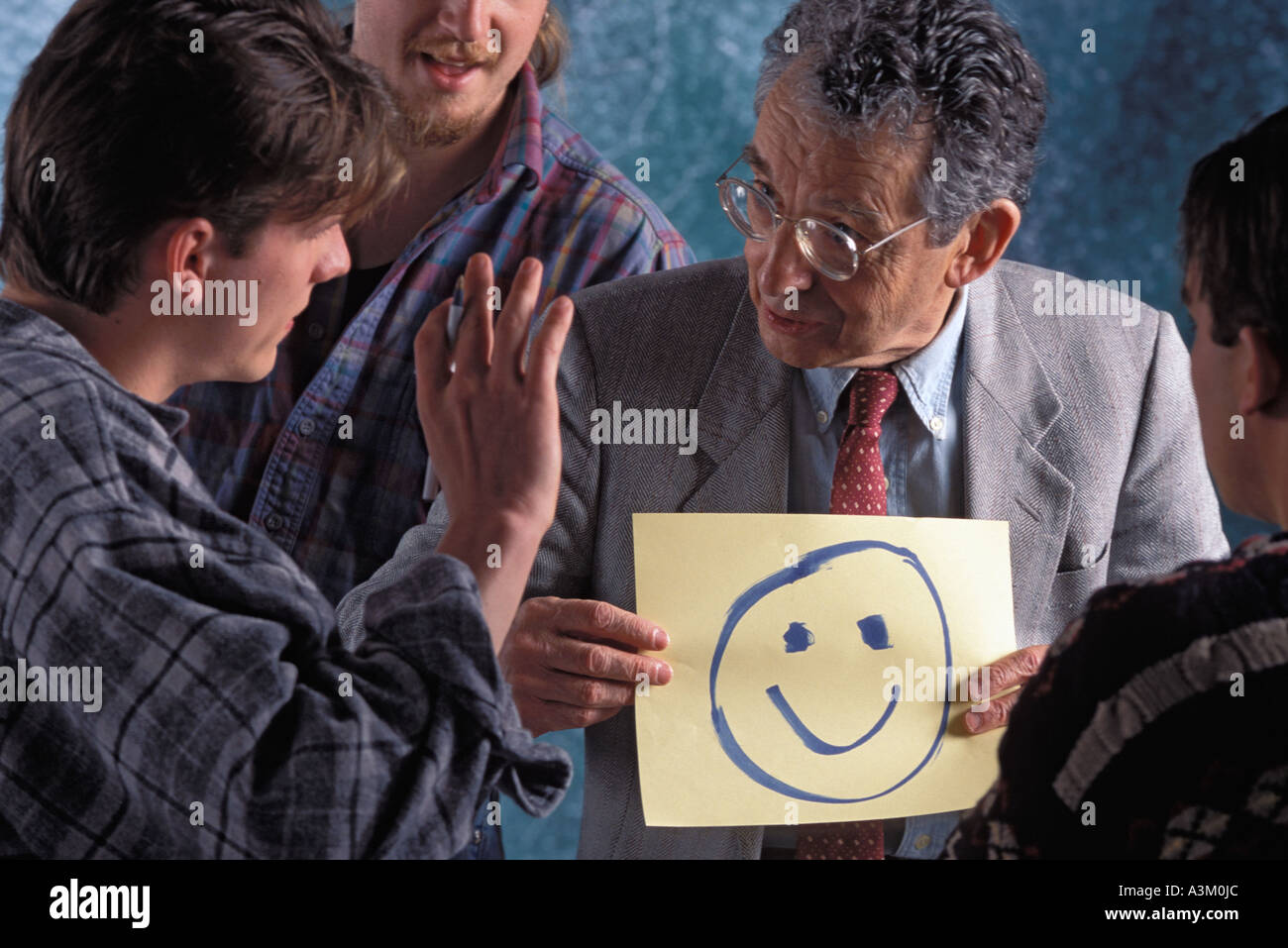 College professor discussing cultural icon with students Stock Photo ...