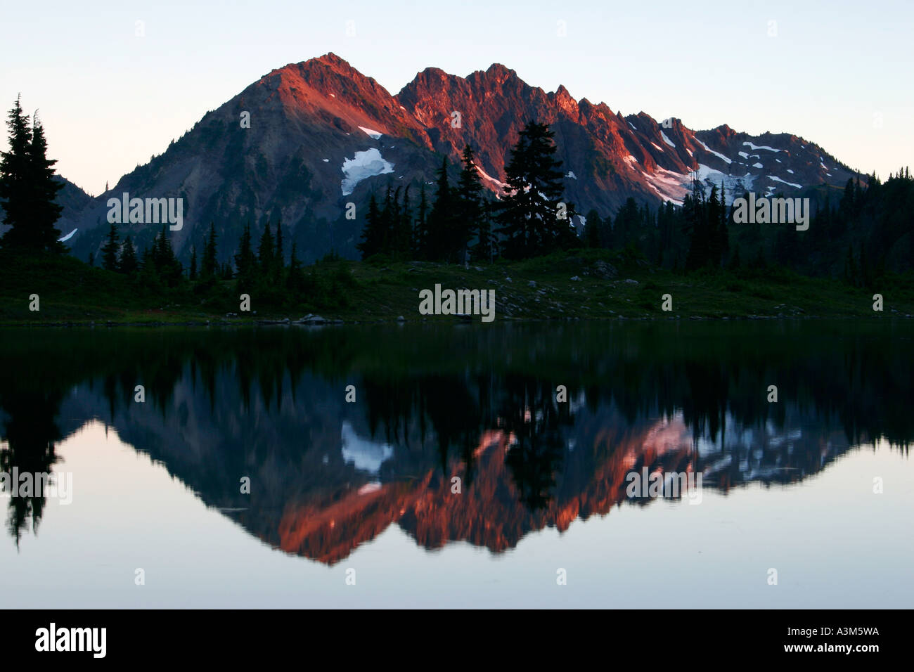 Evening alpenglow on Mt Duckabush reflected in Lake LaCrosse Olympic ...