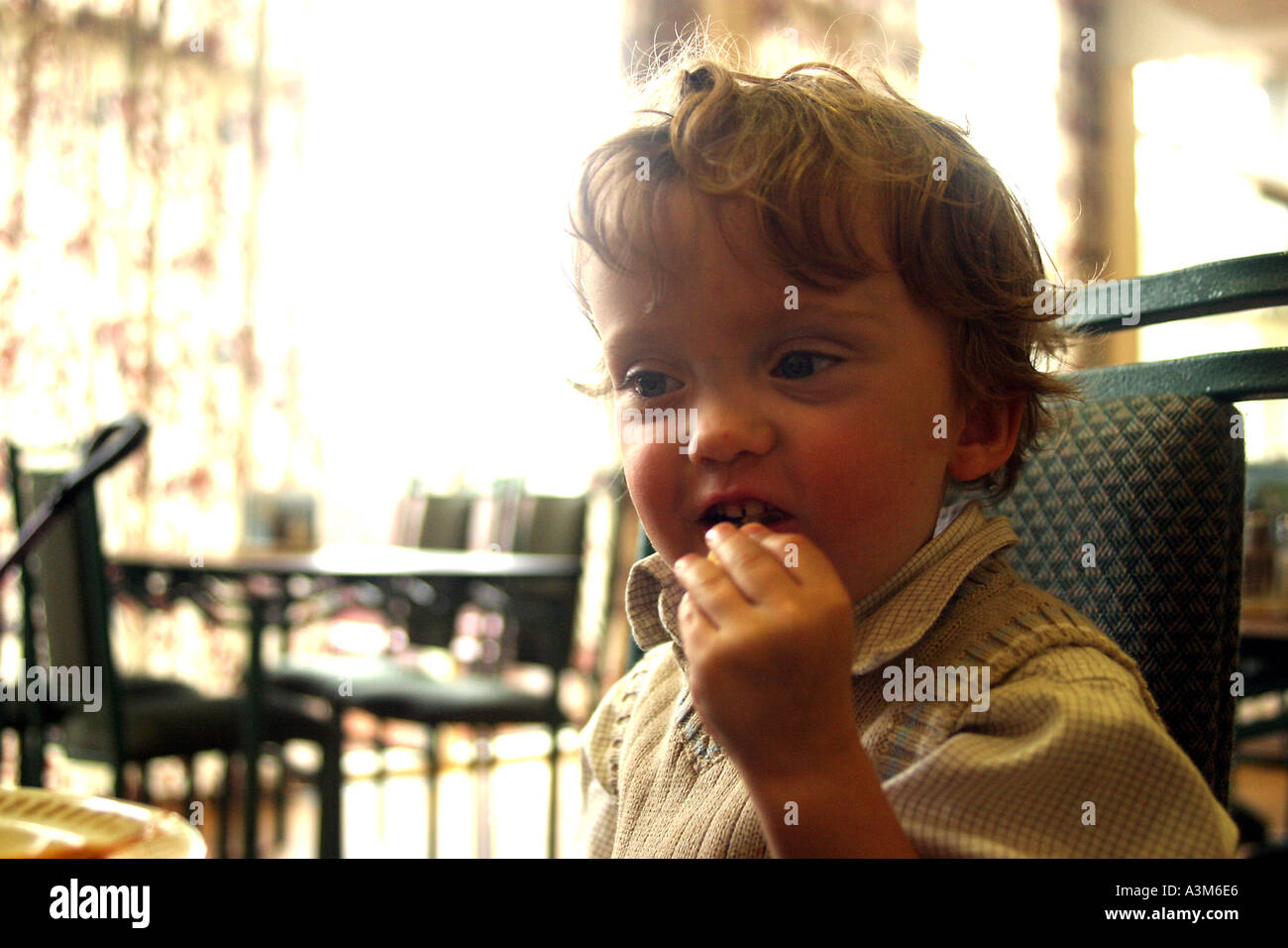 Lewis aged two eating his lunch in a cafe Stock Photo - Alamy