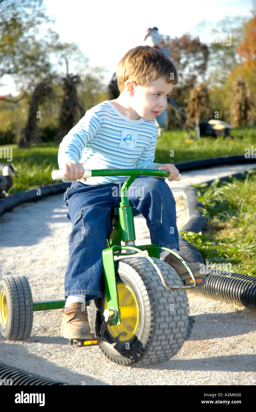 Boy riding a tricycle hi-res stock photography and images - Alamy