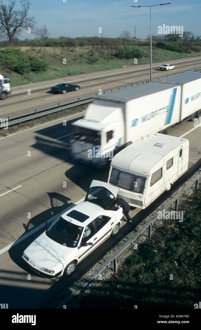 M25 motorway car towing caravan parked on hard shoulder Stock Photo - Alamy