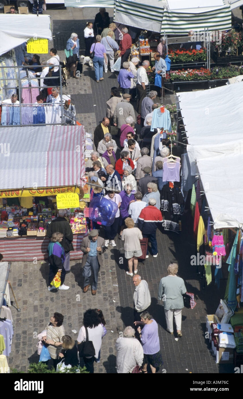 Aerial birds eye view looking down from above people shopping & walking ...