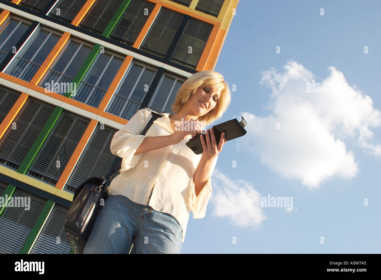 MR Young woman checking something on her PDA Stock Photo - Alamy