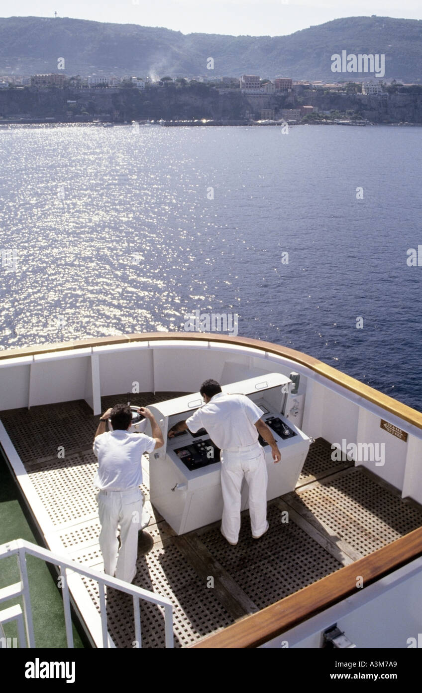 Officers checking instruments on wing bridge of cruise ship approaching ...