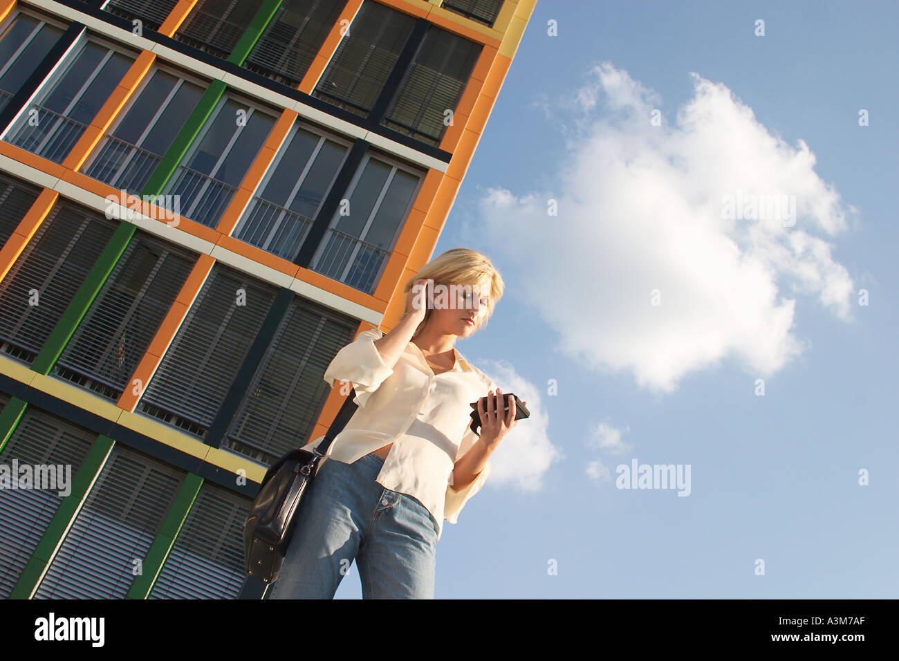 MR Young woman checking something on her PDA Stock Photo - Alamy