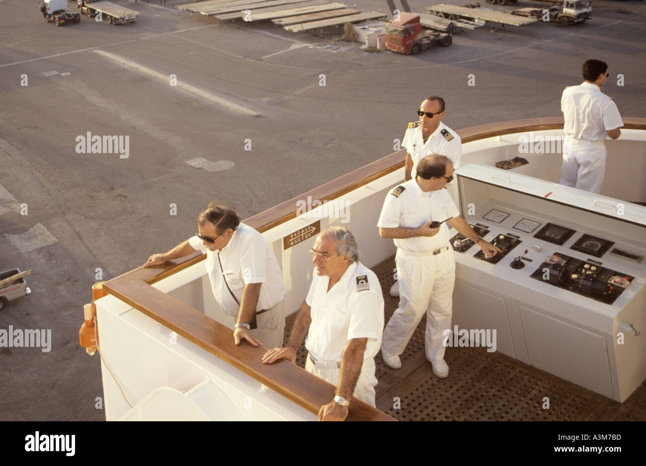 Captain and Officers with local Pilot on wing bridge of cruise ship ...