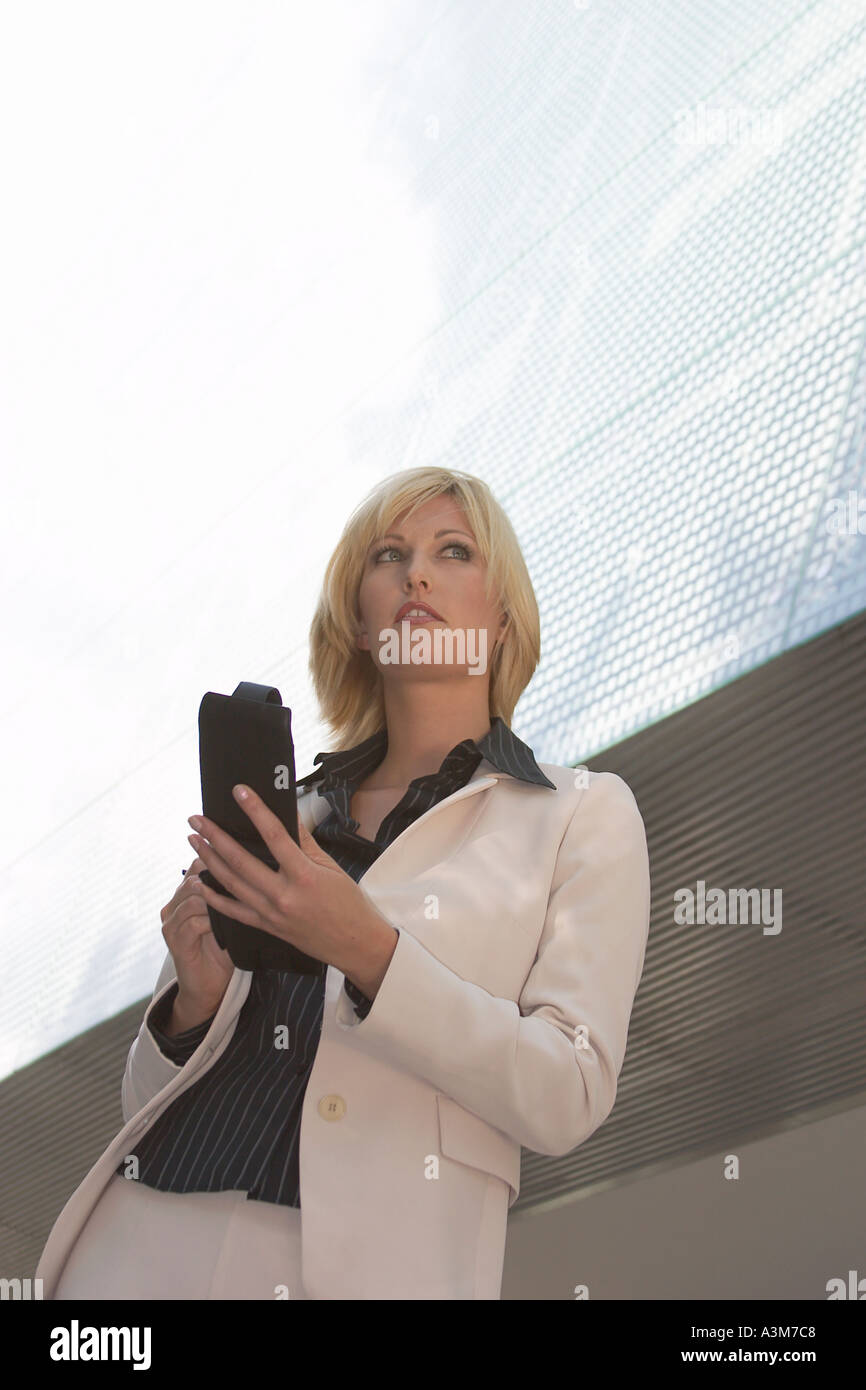 MR Young woman checking something on her PDA Stock Photo - Alamy