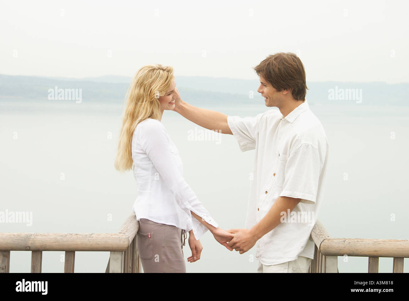 Couple leaning against railing hi-res stock photography and images - Alamy