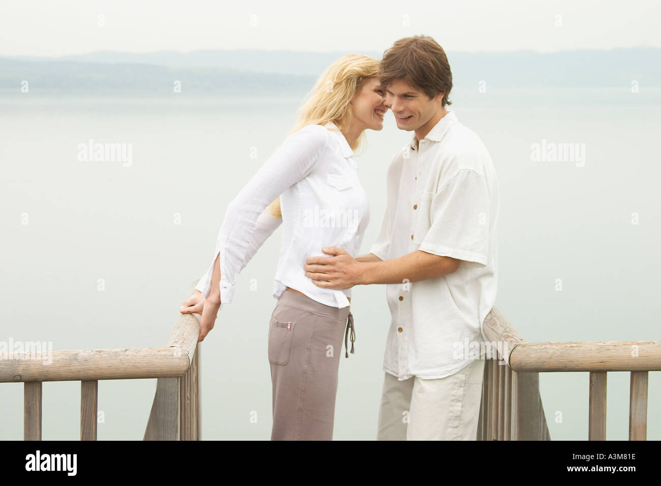 Couple leaning against railing hi-res stock photography and images - Alamy