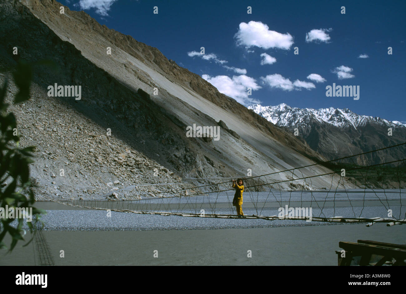 Girl on suspension bridge at Passu village, Upper Hunza valley ...