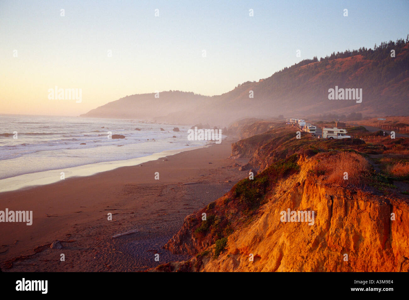 Campers in RV campground on cliff overlooking Pacific Ocean at sunset ...