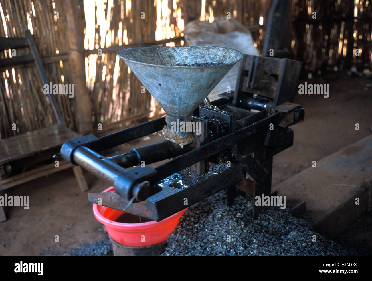 Sunflower seed press in village hut in northern Mozambique near Nampula ...
